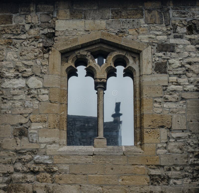 The Old and Ancient Window with Glass Reflection in Stone Wall Stock ...