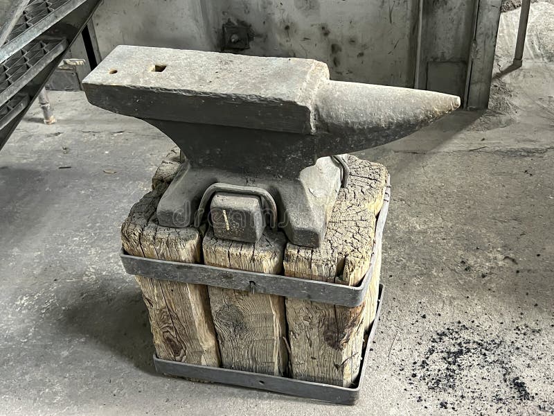 An Old Anvil Standing on a Base Made of Wood Blocks Stock Photo - Image ...