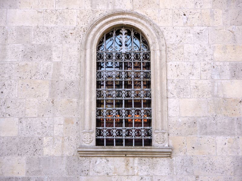 Old Arced Window with Cast Iron Grill and White Stone Blocks Frame ...