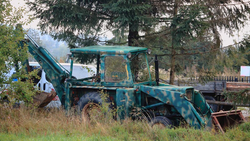 An Old Backhoe Loader Standing Somewhere among the Greenery Stock Image ...