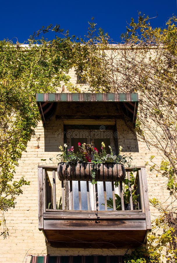 Old Balcony with Flowers on Buildings and Blue Sky Stock Photo - Image ...