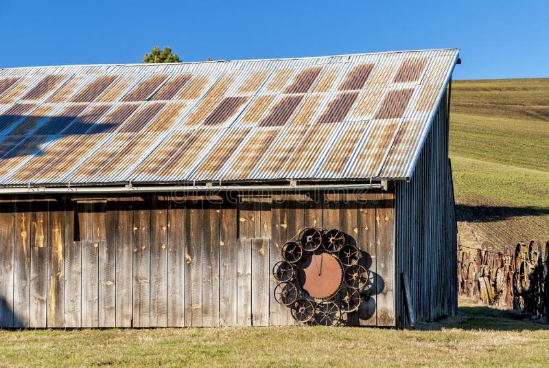 Old Barn with Blue Sky and Wagon Wheels Stock Image - Image of metal ...