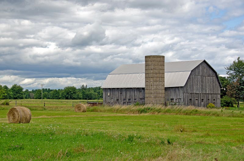 Old barn with hay bales stock image. Image of silo, cloud - 32920047