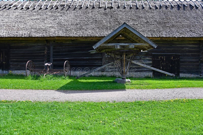 The Old Barn with Some Equipment Stock Photo - Image of tools, grass ...