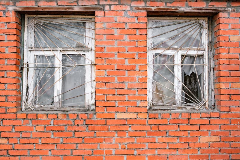 Old Barred Windows on the Brick Wall of the House Stock Image - Image ...