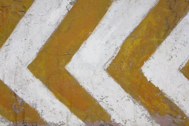 Old Battered Concrete Wall with Yellow and White Arrows Signifying ...