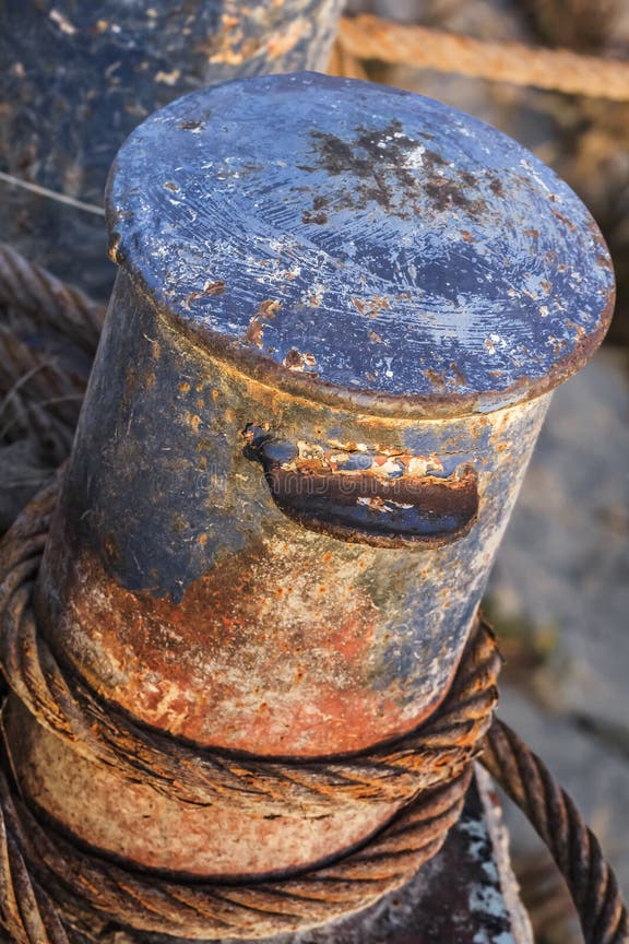 Old Battered Rusty Iron Bollard with Coiled Corroded Steel Cable Stock ...