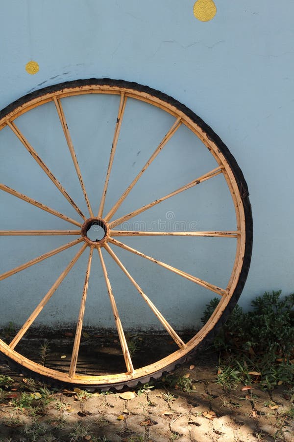 Bicycle Wheel Rests Against the Wall Stock Photo - Image of blue ...