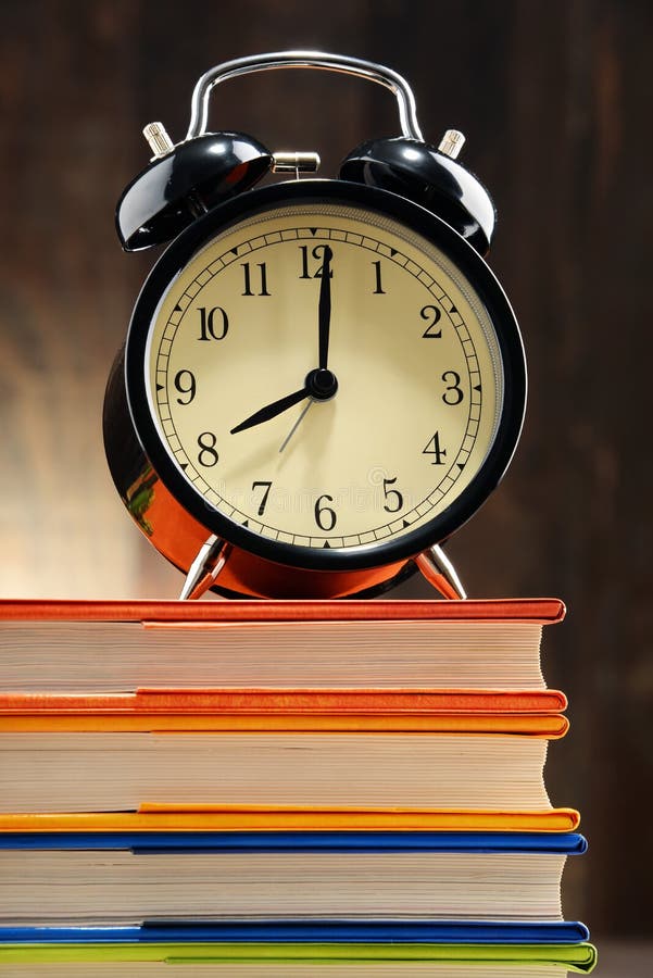 Old Black Alarm Clock on the Stack of Books Stock Image - Image of book ...