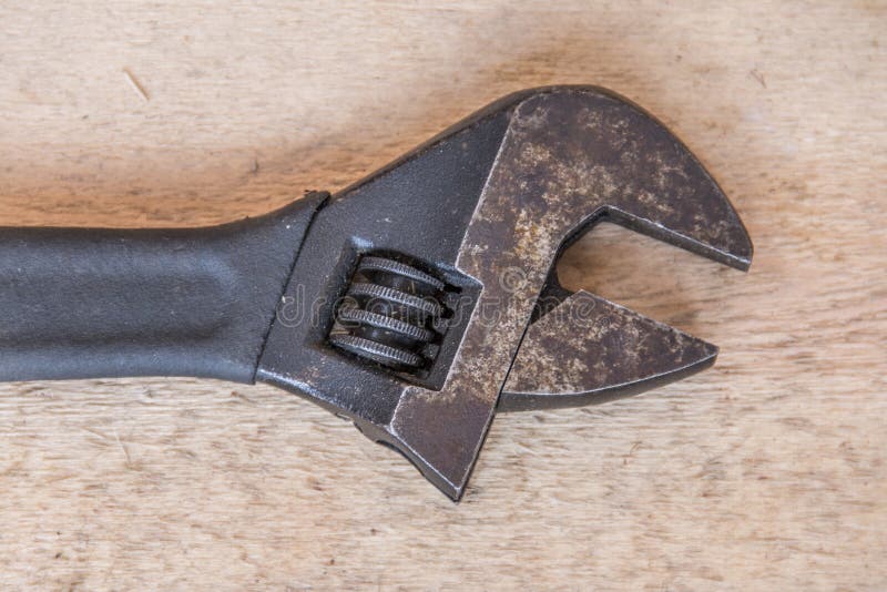 A Large Old Adjustable Spanner Lies on a Wooden Surface Stock Image ...