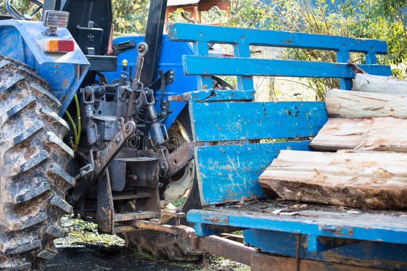 Old Blue Farm Tractor Carrying Wood Logs Stock Image - Image of logs ...
