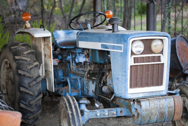 Old Blue Tractor in Outdoors Open Shed Stock Image - Image of tires ...