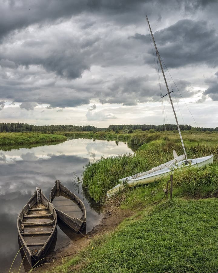 Old Boats on the Bank of a Small River Stock Photo - Image of edge ...
