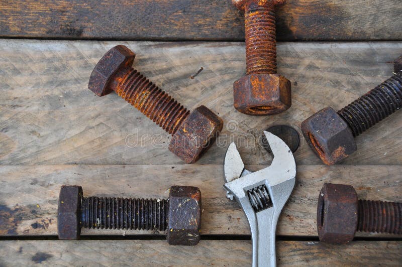 Old Bolts with Adjustable Wrench Tools on Wooden Background Stock Photo ...