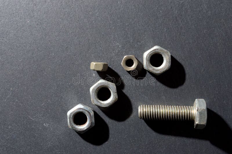 Bolts and Nuts of Different Sizes Lie on a White Background. Top View ...