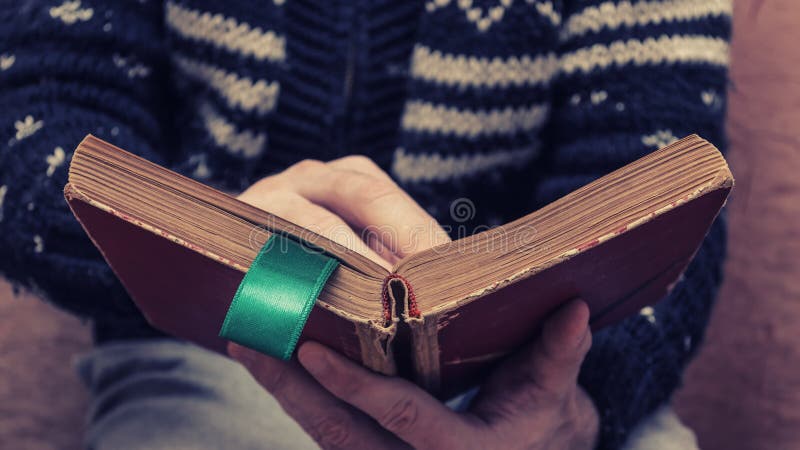 Old Book in His Hands, with a Ribbon between the Pages Stock Photo ...