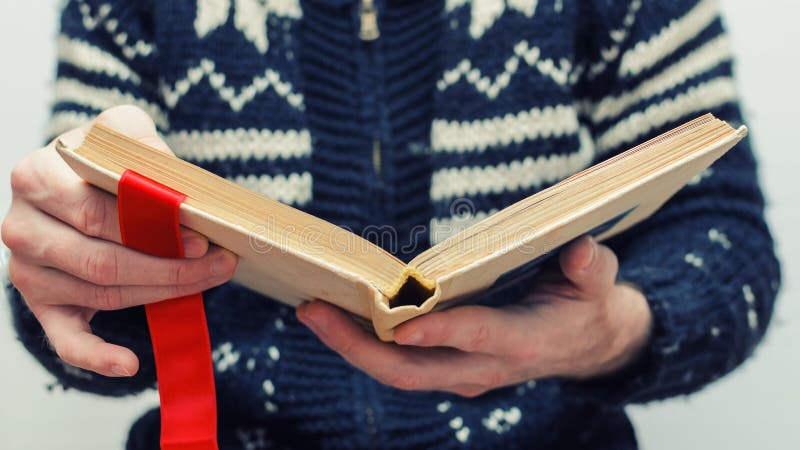 Old Book in His Hands, with a Ribbon between the Pages Stock Photo ...