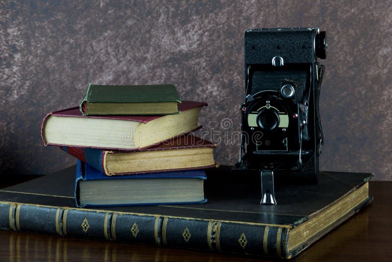 Old Books and Old Folding Camera on a Varnished Wooden Surface Stock ...