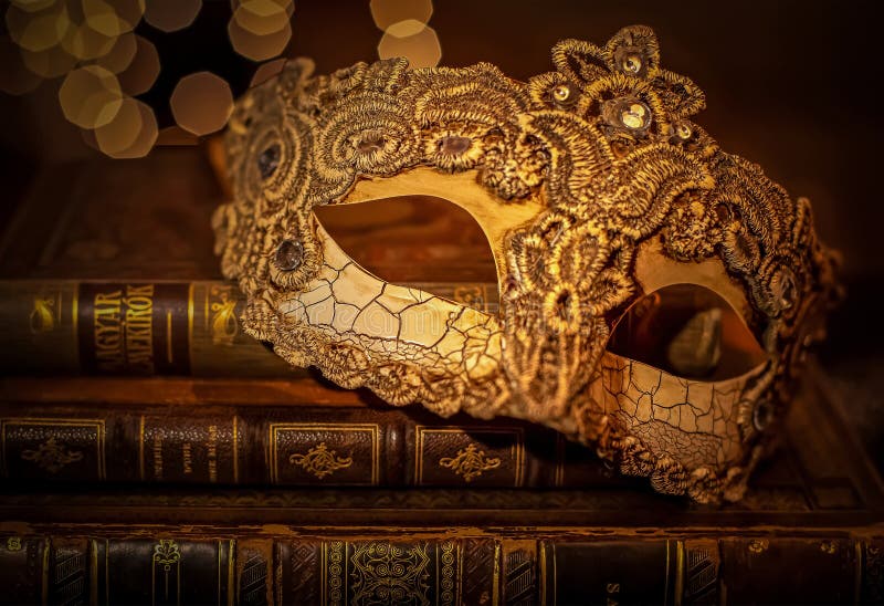 Old books with a mask stock photo. Image of costume - 325304224