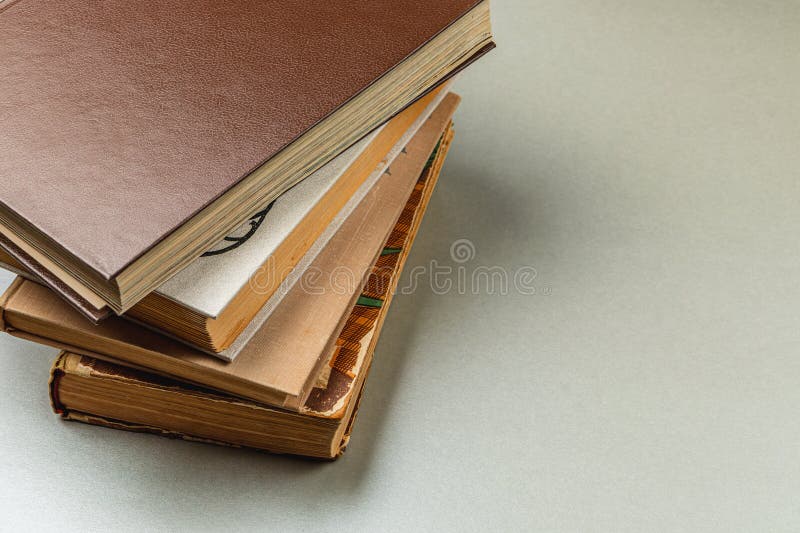 Old Books Stacked on a Light Surface Showcasing Various Cover Textures ...