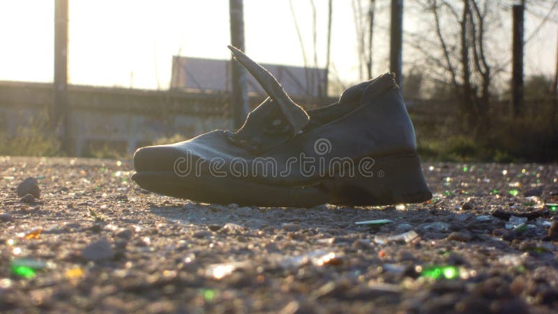 An Old Boot in the Midst of Urban Trash, Lie on the Pavement Under the ...