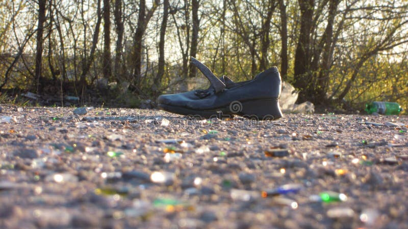 An Old Boot in the Midst of Urban Trash, Lie on the Pavement Under the ...