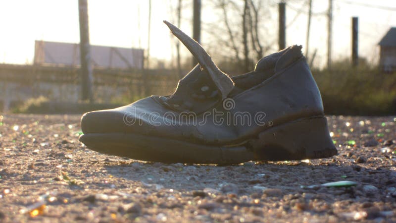 An Old Boot in the Midst of Urban Trash, Lie on the Pavement Under the ...