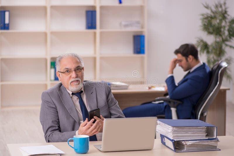 Old Male Boss and Young Male Employee in the Office Stock Image - Image ...