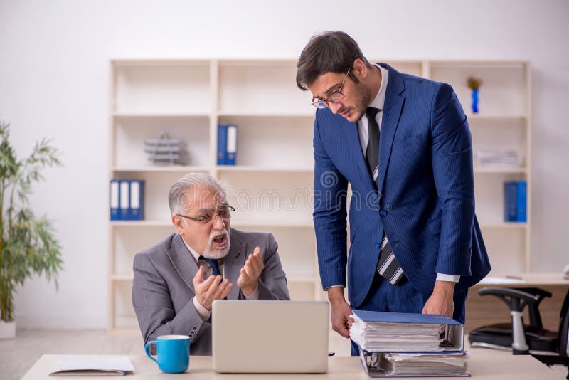 Old Male Boss and Young Male Employee in the Office Stock Photo - Image ...