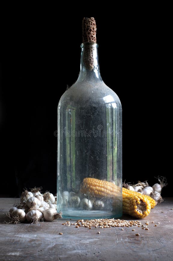 Old Bottle of Alcohol with Maize, Corn and Garlic Stock Photo - Image ...