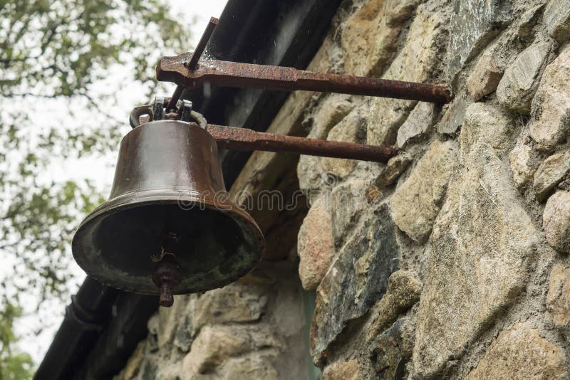 Old Brass Bell on a Stone Wall. Old Way of Wireless Communication and ...