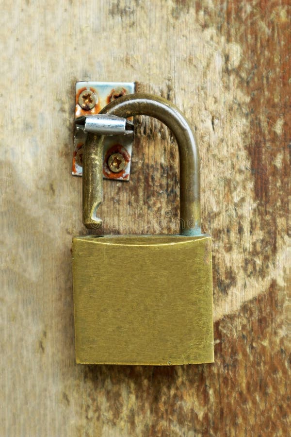 Old Brass Padlock Hanging on the Wooden Door Stock Photo - Image of ...