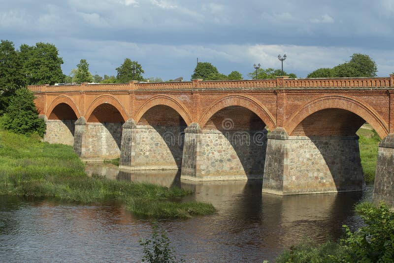 An Old Brick Bridge with a Reflection in the River Stock Photo - Image ...