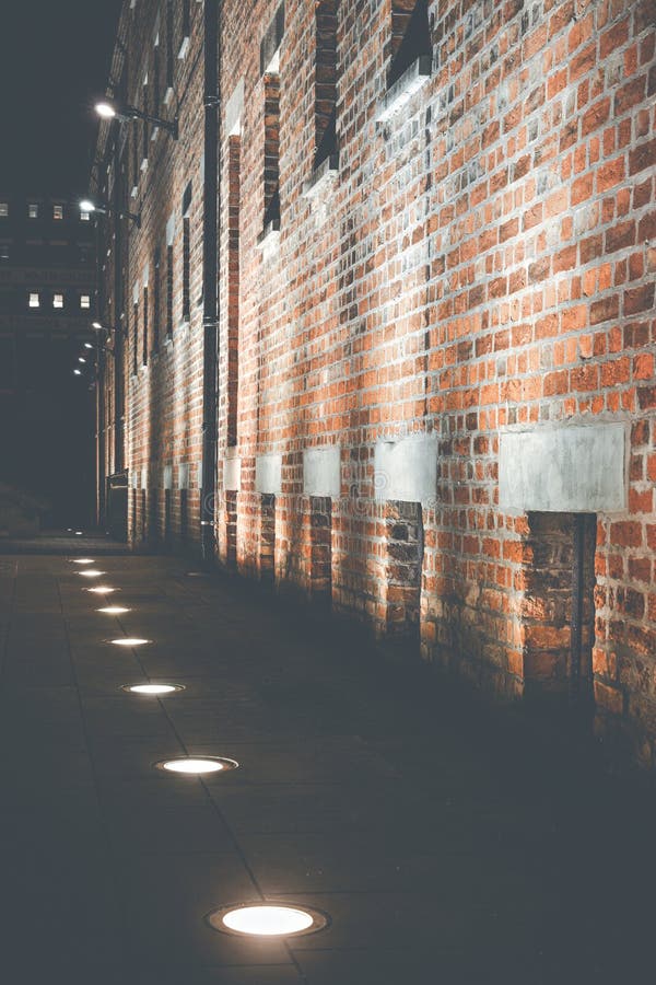 Old Brick Building Illuminated by Bright Lamps at Night Stock Photo ...