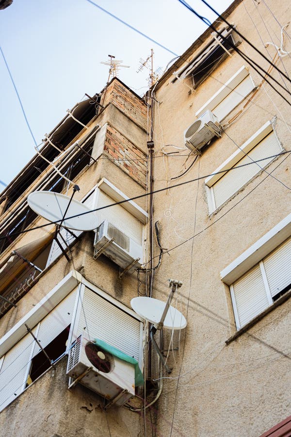 Old Brick Building with Ventilation Systems, Wires and Cables on Each ...