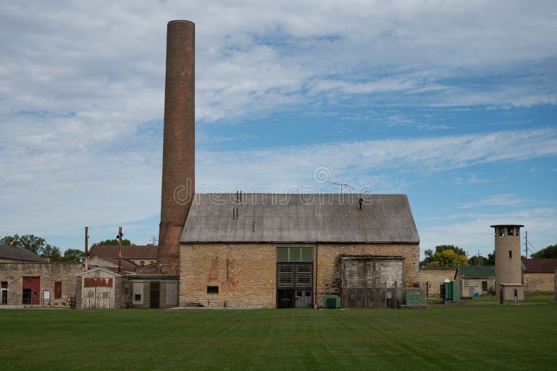 An Old Brick Building with a Very Big Chimney in the Back Stock Image ...