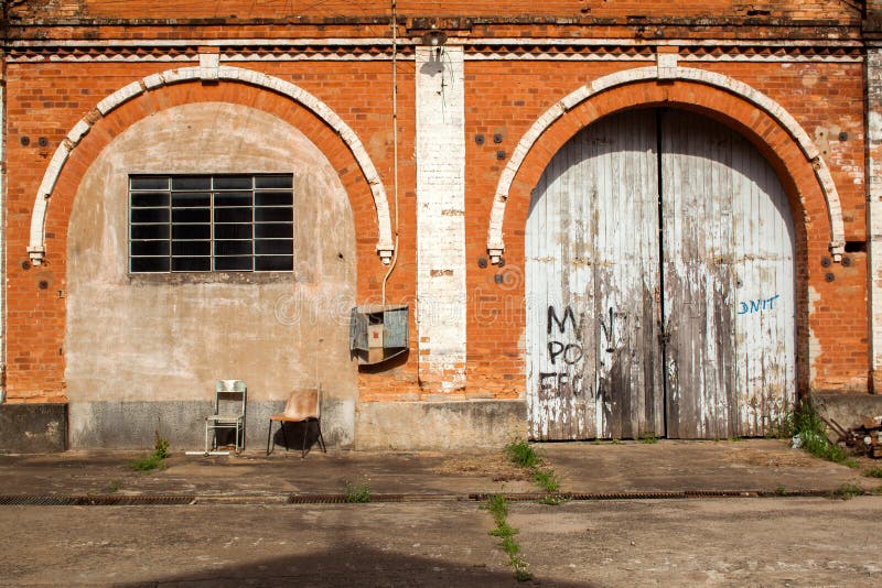 Old Brick Wall with Closed White Gates Stock Photo - Image of orange ...