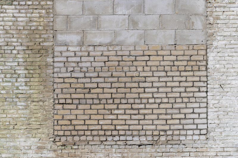 An Old Brick Wall Made of a Large Number of Different Types of Bricks ...