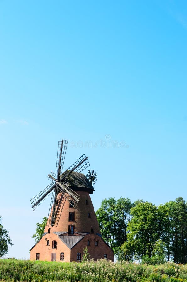 Old Brick Windmill on Field on Blue Sky Background Stock Photo - Image ...