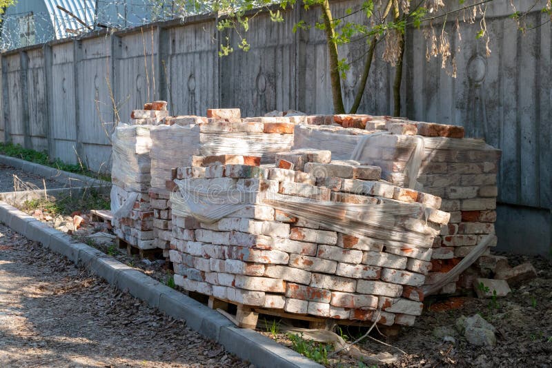 Old Bricks Stacked on a Wooden Frame Partially Covered with ...