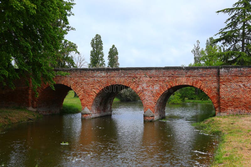 Old Bridge Made of Red Bricks with Three Perfect Arches Over a Canal ...