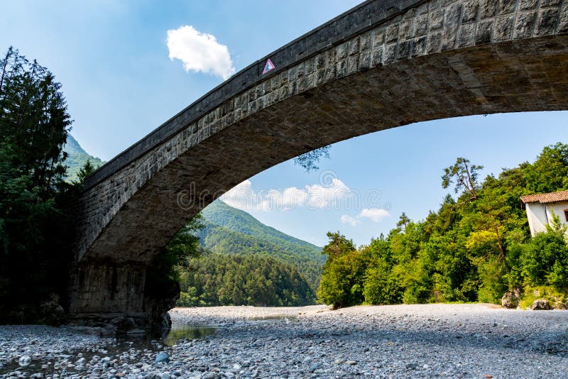Old bridge over the river stock image. Image of tagliamento - 62371239