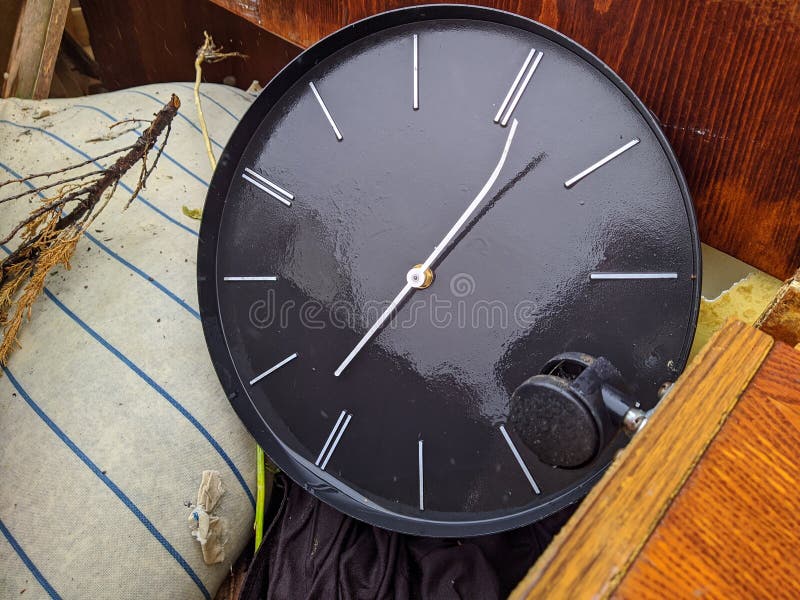 Old and Broken Black Clock in a Garbage Dump in a Rainy Time. Stock ...