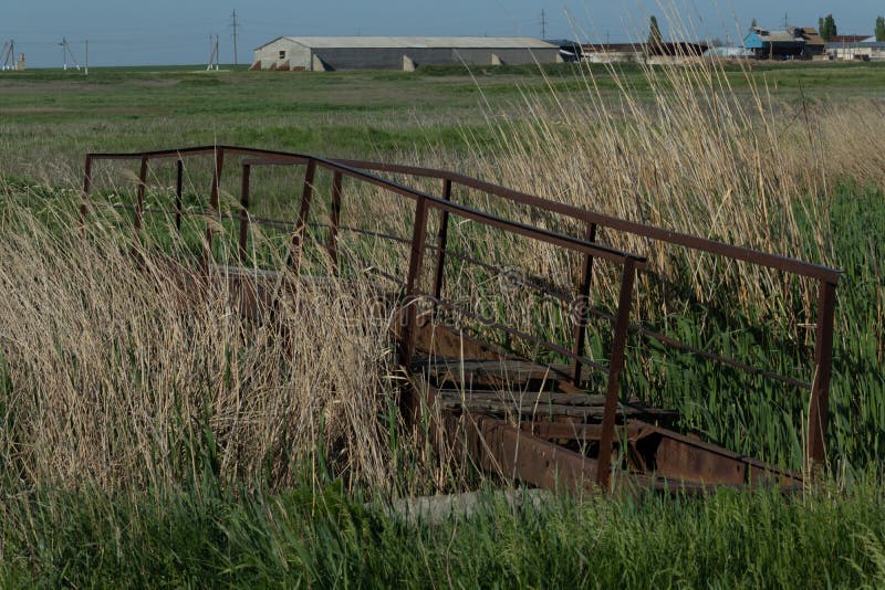 Old Broken Bridge Over the River Near the Farm Buildings Stock Photo ...