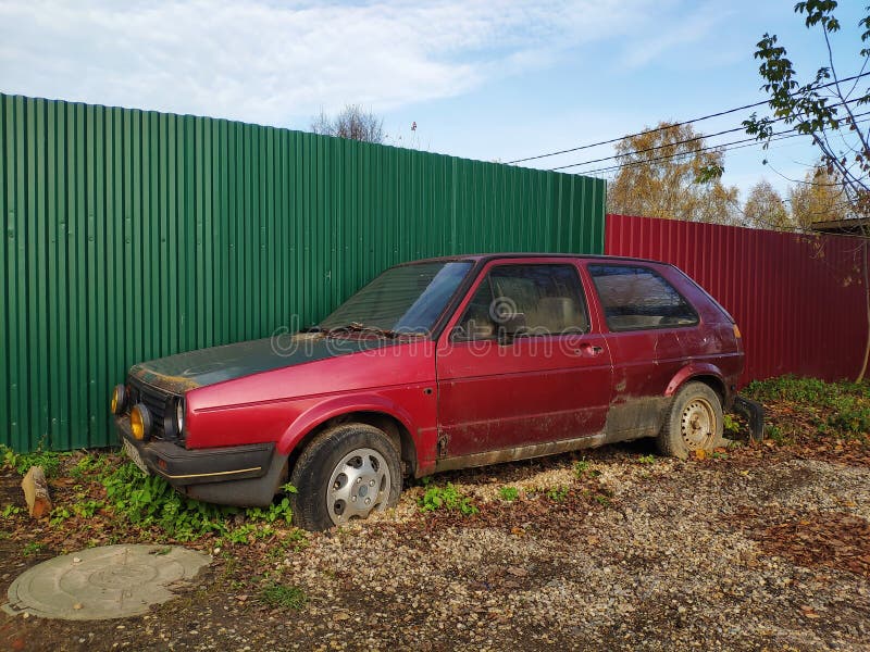Old Broken Car. Abandoned Rusty Car at the Fence in the Yard Editorial ...