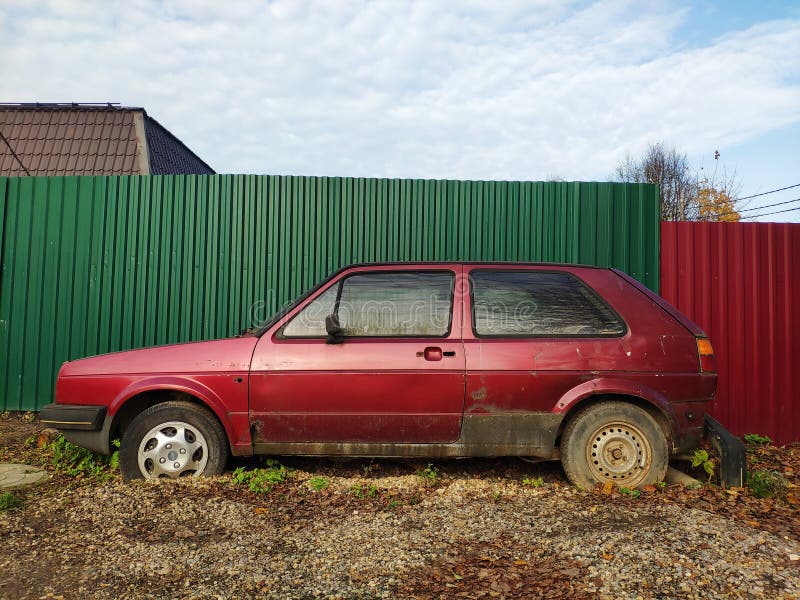 Old Broken Car. Abandoned Rusty Car at the Fence in the Yard Editorial ...
