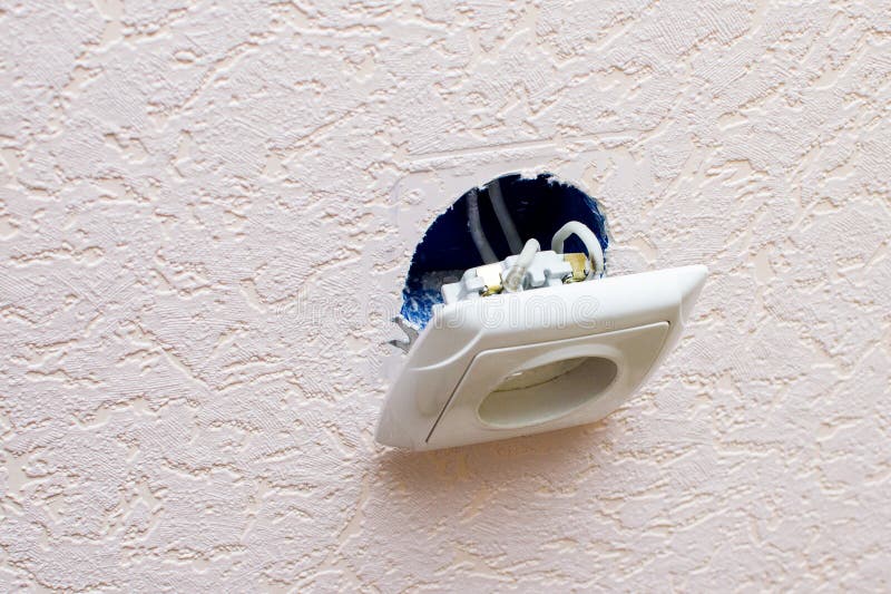 Broken Electrical Outlet in Beige Wall. White Electrical Outlet with ...