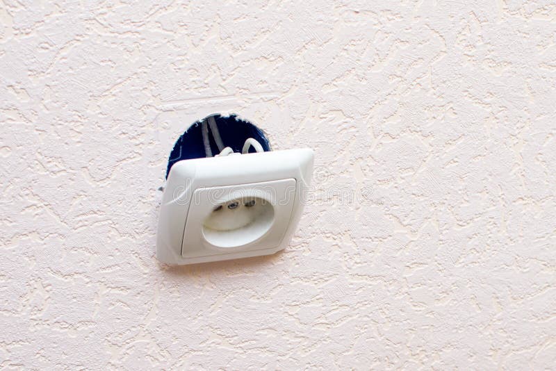 An Old Broken Electrical Outlet Fell Out of the Wall, Danger of ...