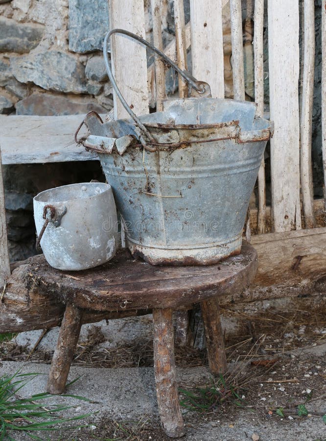 Old Broken Bucket and an Aluminum Pan on the Wooden Stool Stock Image ...