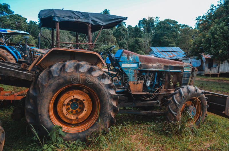 Old Broken Tractor Stands in the Backyard of a Rural House. Stock Image ...